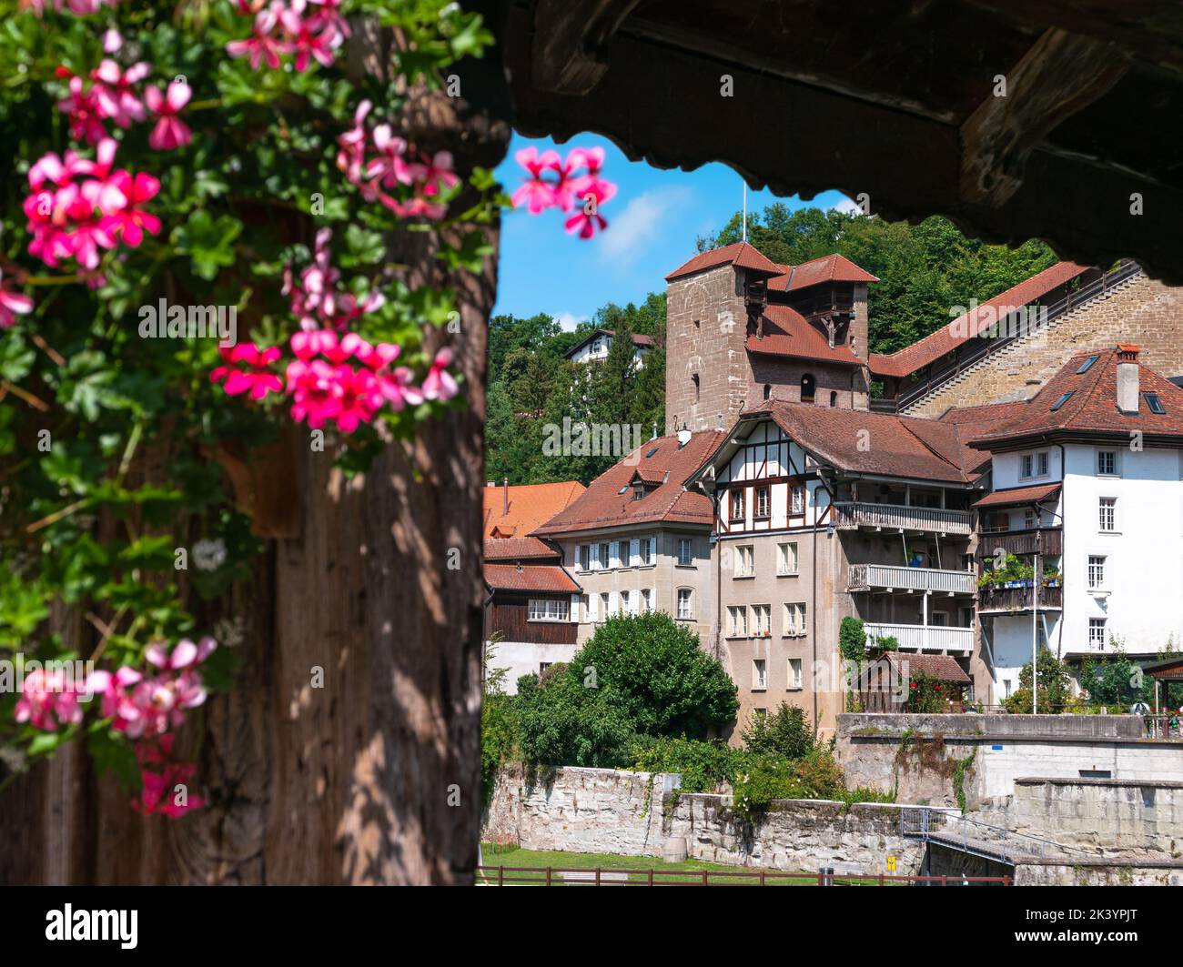 Old medieval town of Fribourg through old wooden bridge over the Saane ...