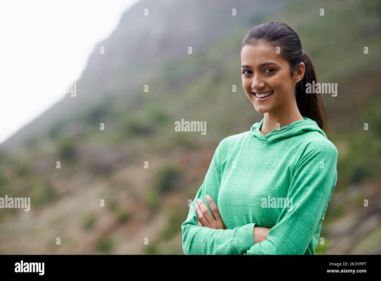 She loves trail running. A beautiful young woman standing against a ...