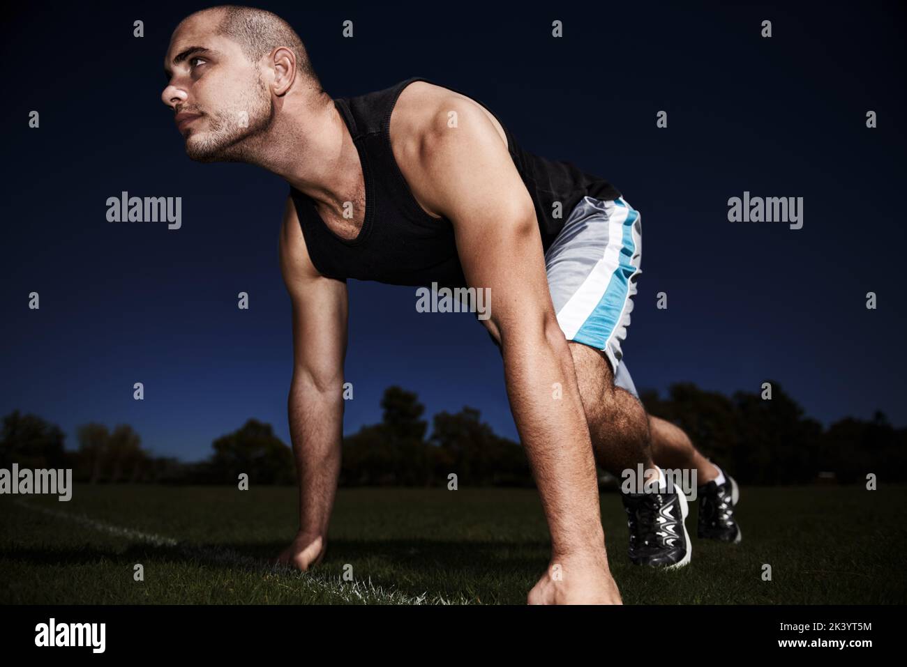 Hes ready to win. A young man in the starting position for a race Stock ...