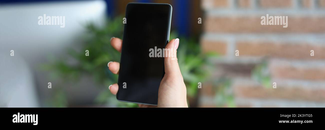 Woman hold in hand smartphone with black screen, turn off mobile phone ...