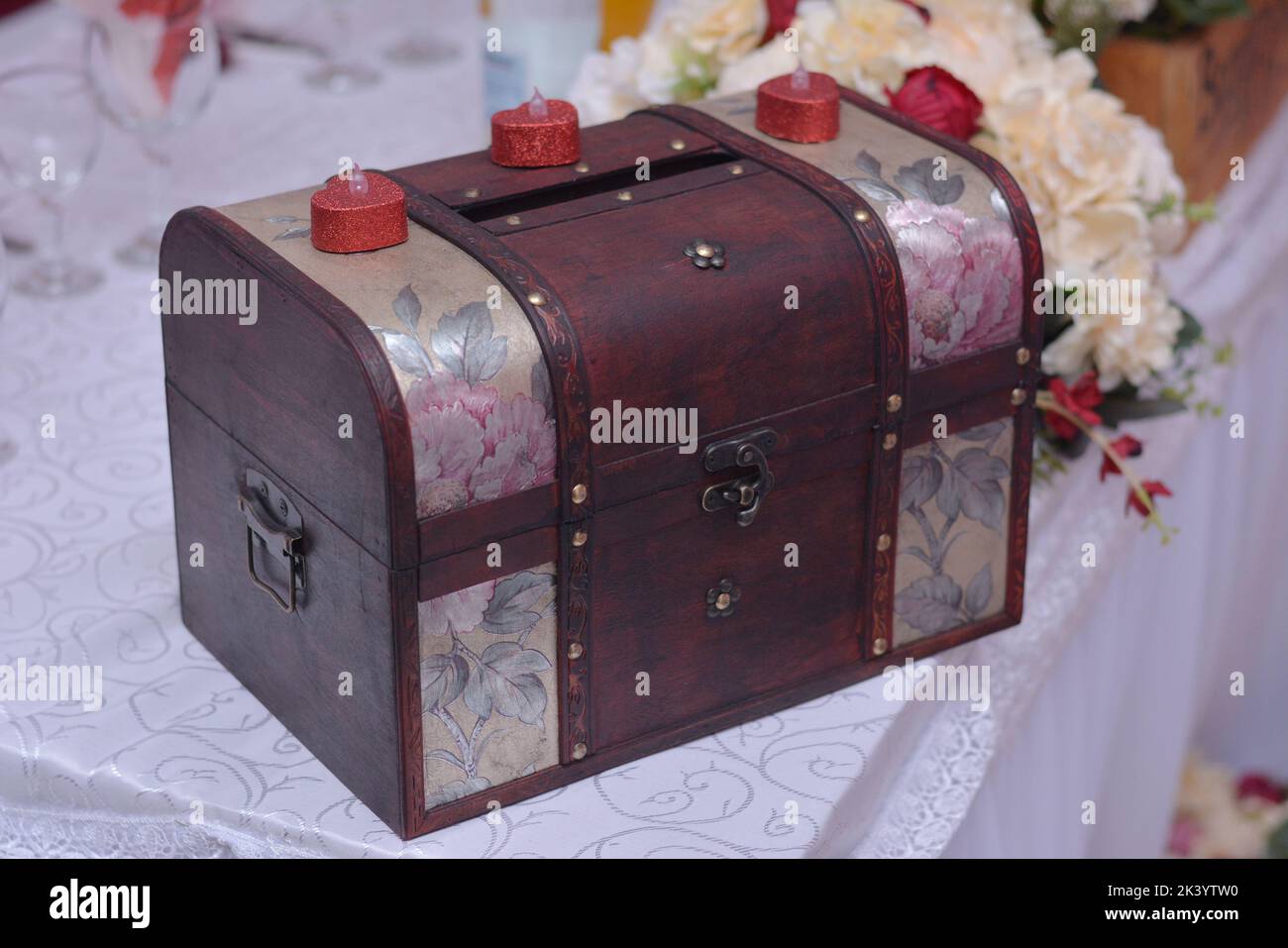 Old wedding coffer for money with red candles Stock Photo - Alamy