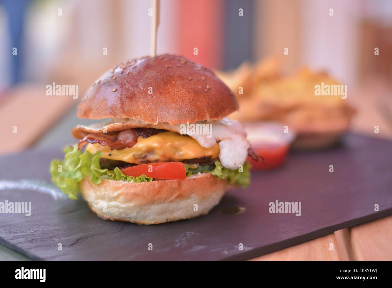 Burger menu with egg, chicken, beef, tomatoes and salad, on the black ...
