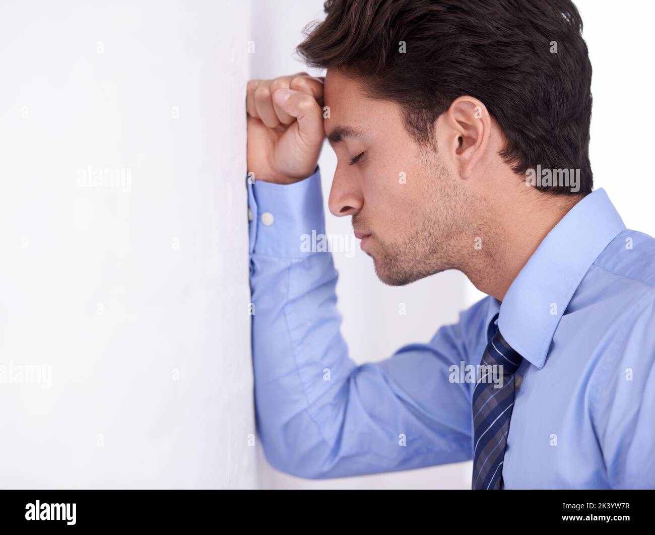 Business man leaning head to wall hi-res stock photography and images ...