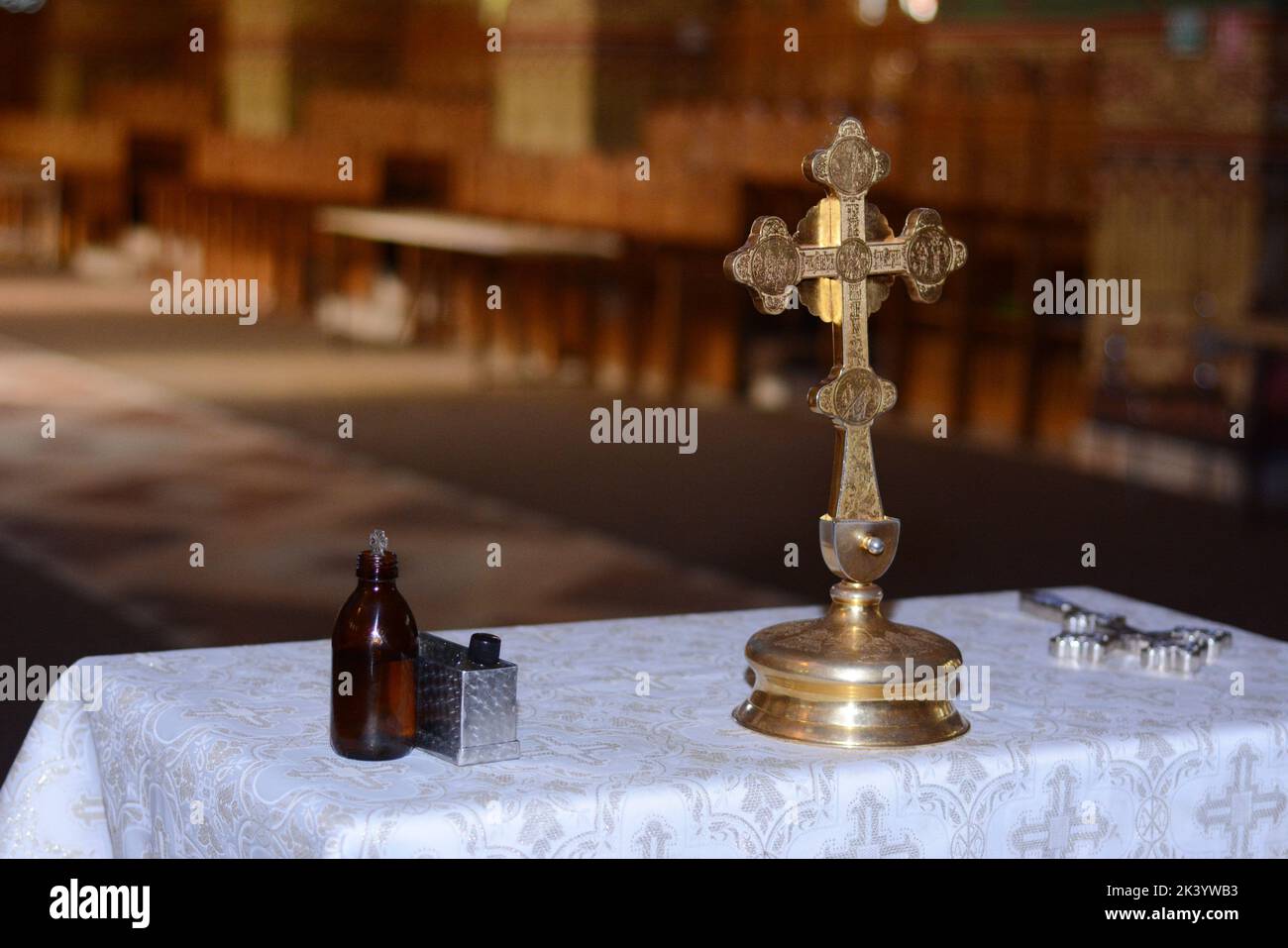 Holy cross and the holy oil, ready for baptism ceremony Stock Photo - Alamy