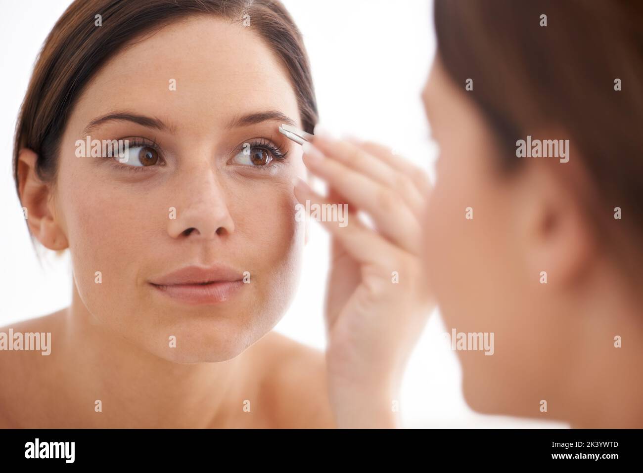 Shes already near-perfect. An attractive young woman plucking her ...