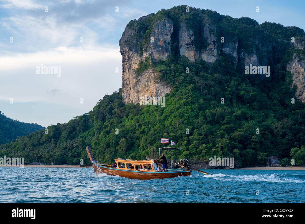 An aerial view of long tail boat floating in sea in background of ...