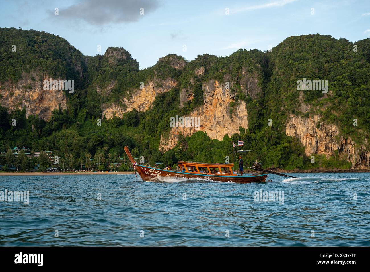 An aerial view of long tail boat floating in sea in background of ...