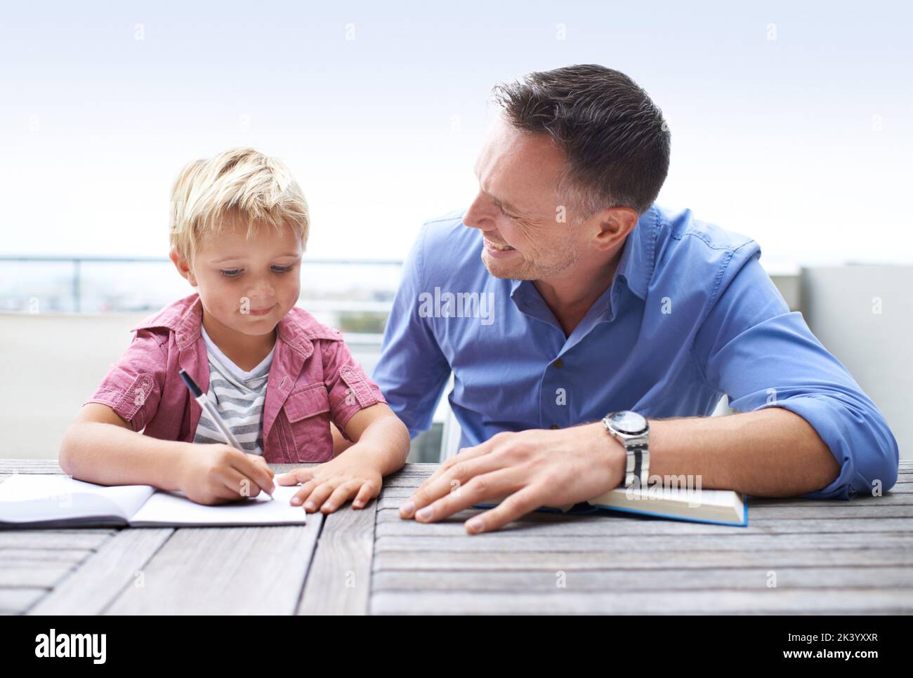 Creative coloring. a father helping his son with his coloring book ...