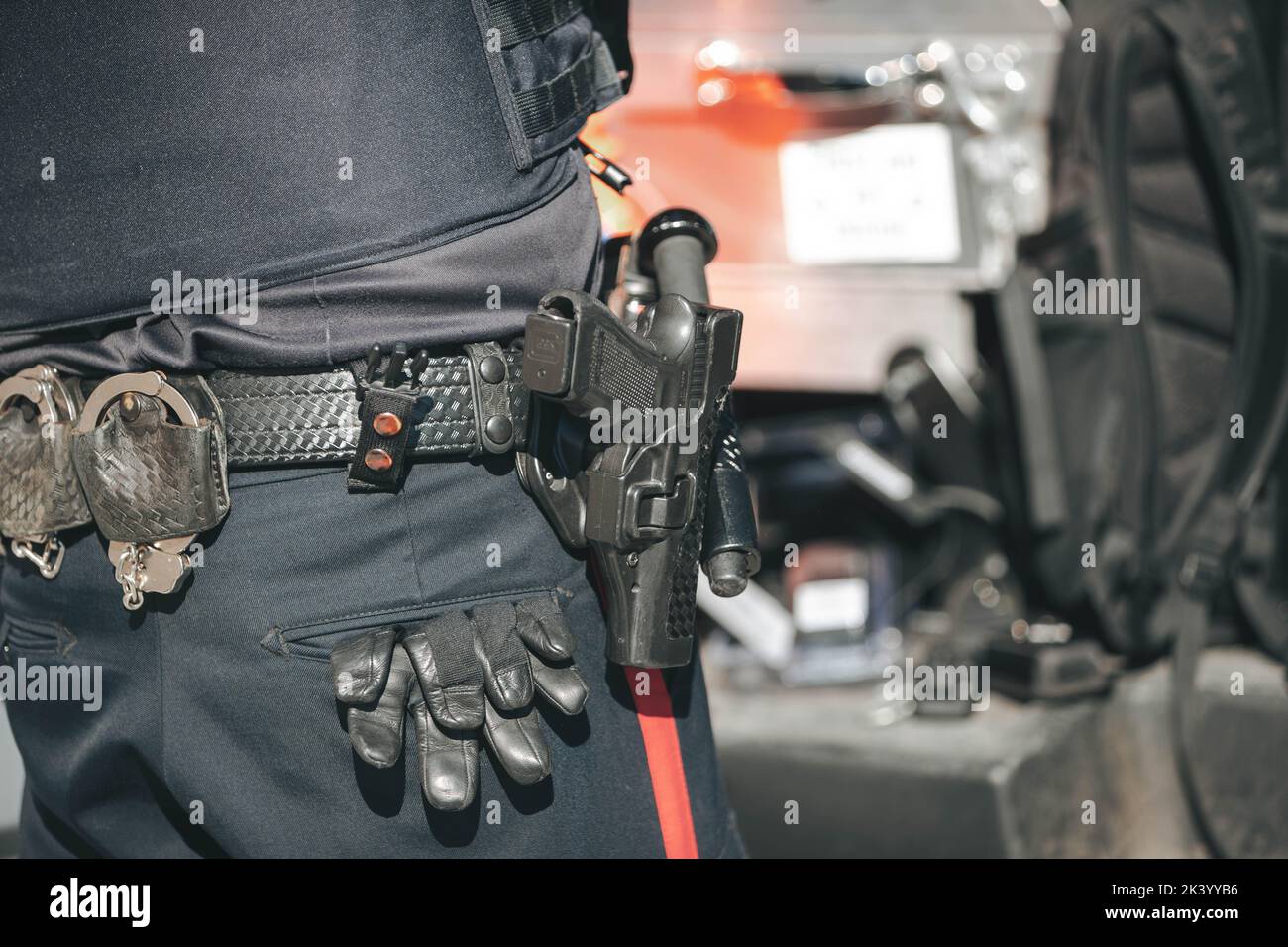 A closeup of police officer with handcuffs and handgun Stock Photo - Alamy