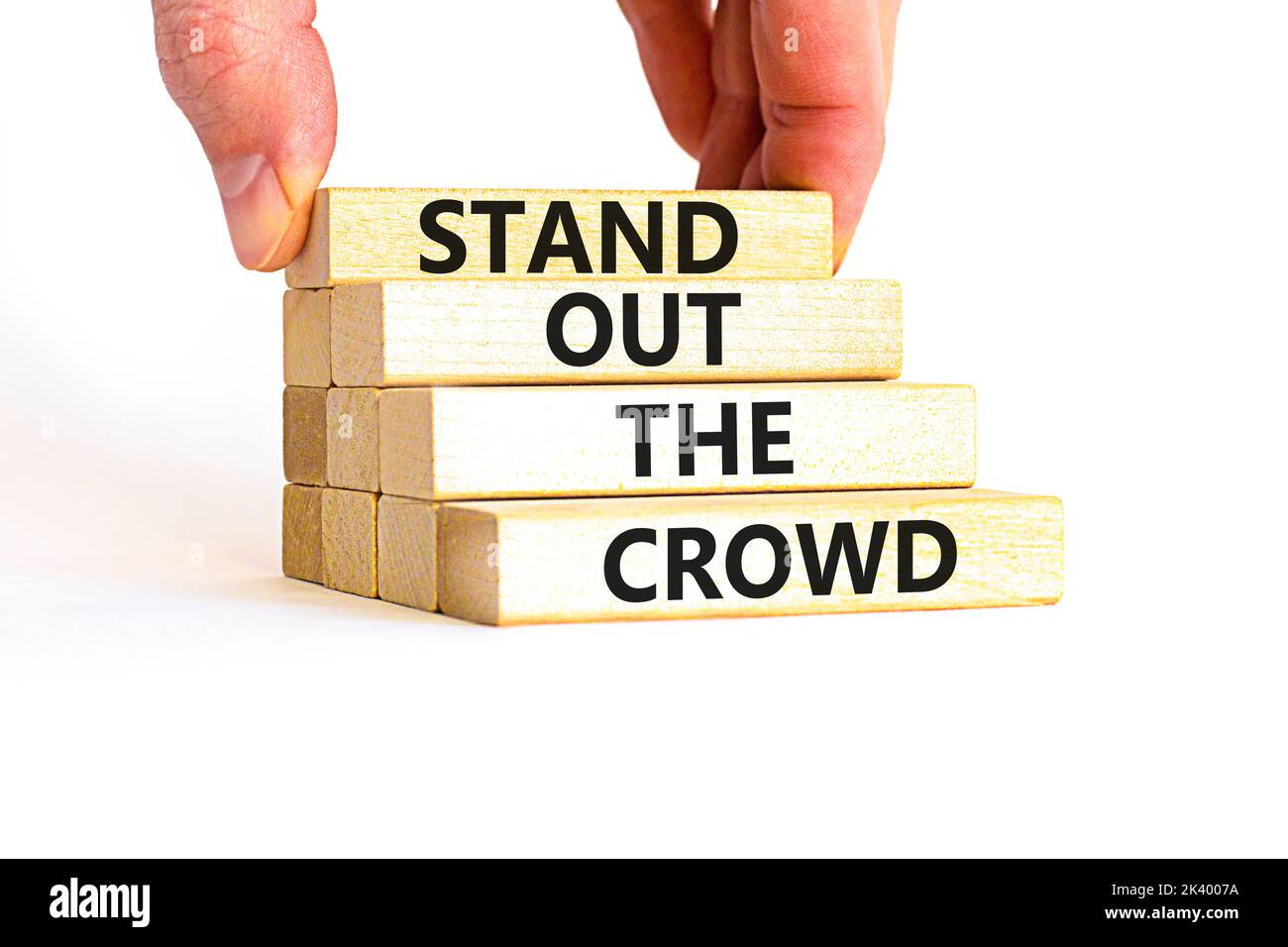 Stand out the crowd symbol. Concept words Stand out the crowd on wooden ...