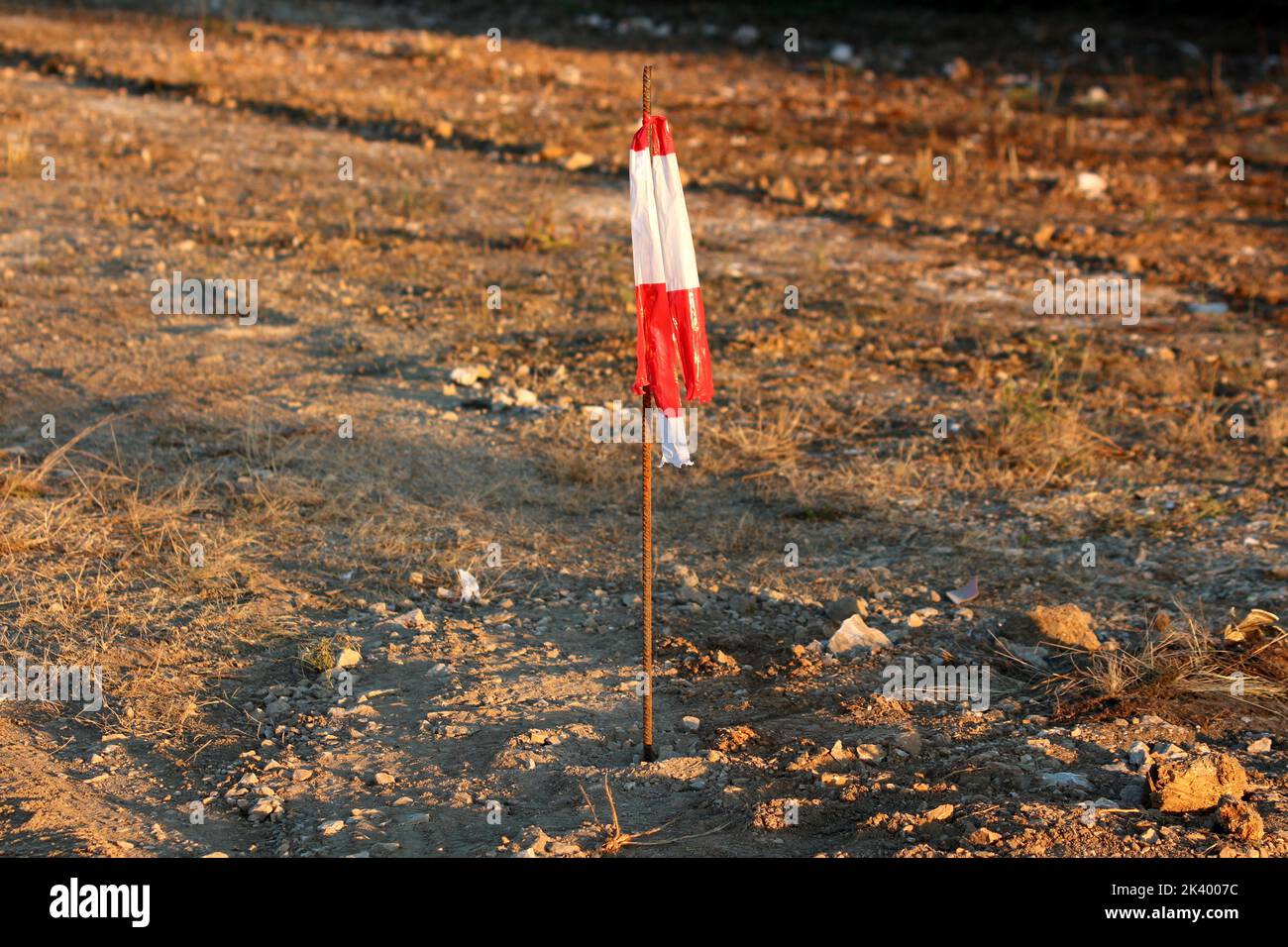 Bright new red and white signal striped hazard warning tape tied on top ...