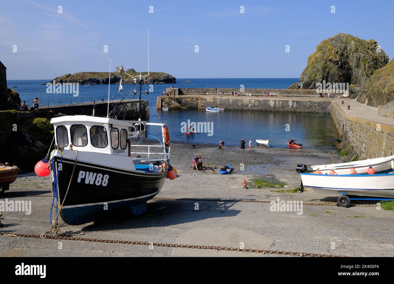 Mullion Cove, Cornwall on a calm day in late summer. The cove is used ...