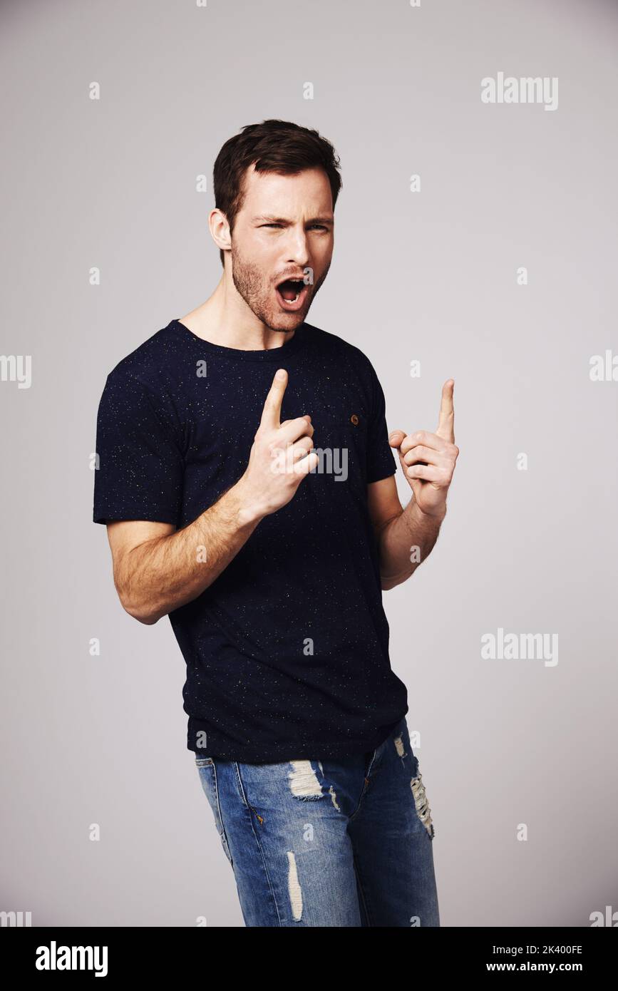 Celebrating his achievements. A handsome young man celebrating in ...