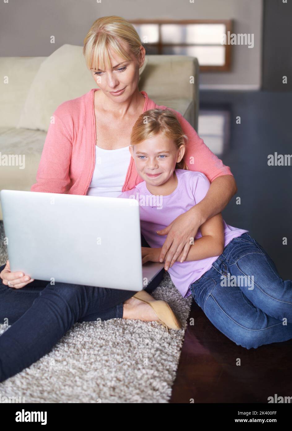 In touch with family online. a mother and daughter sitting on their ...