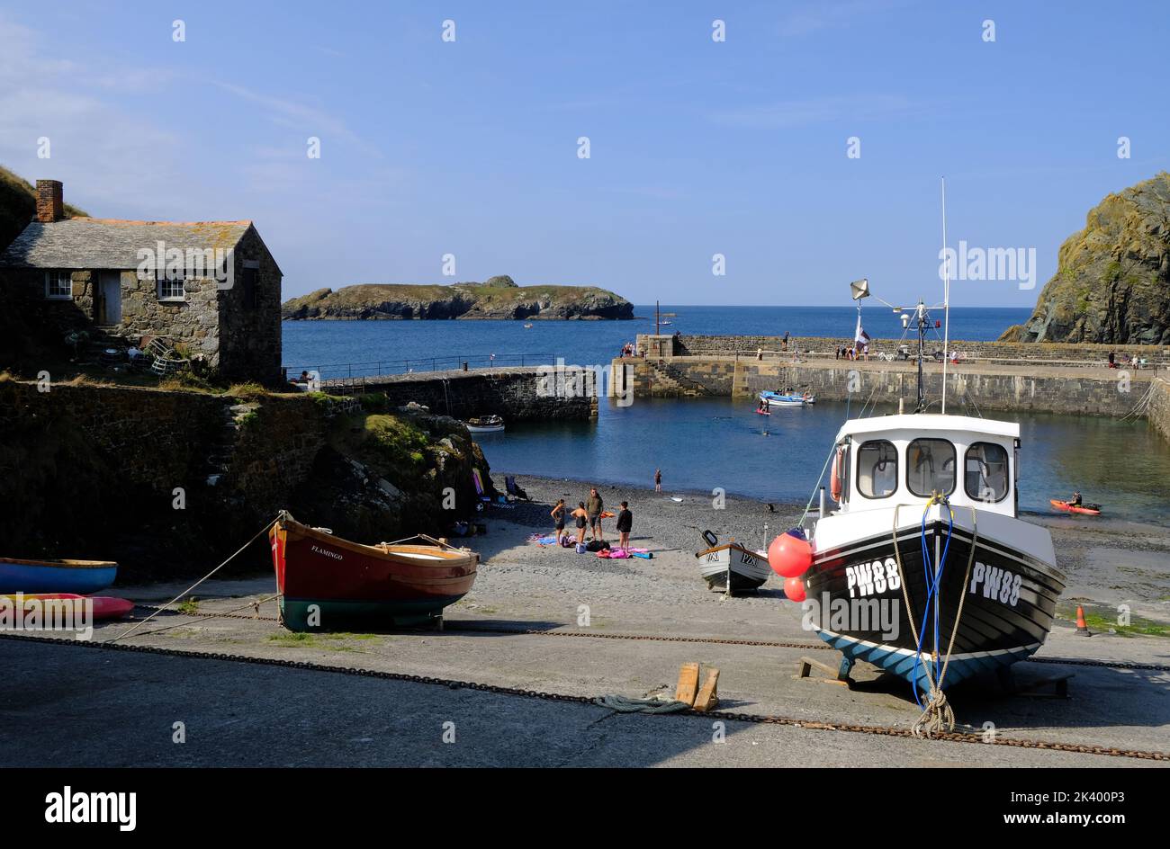 Mullion Cove, Cornwall on a calm day in late summer. The cove is used ...