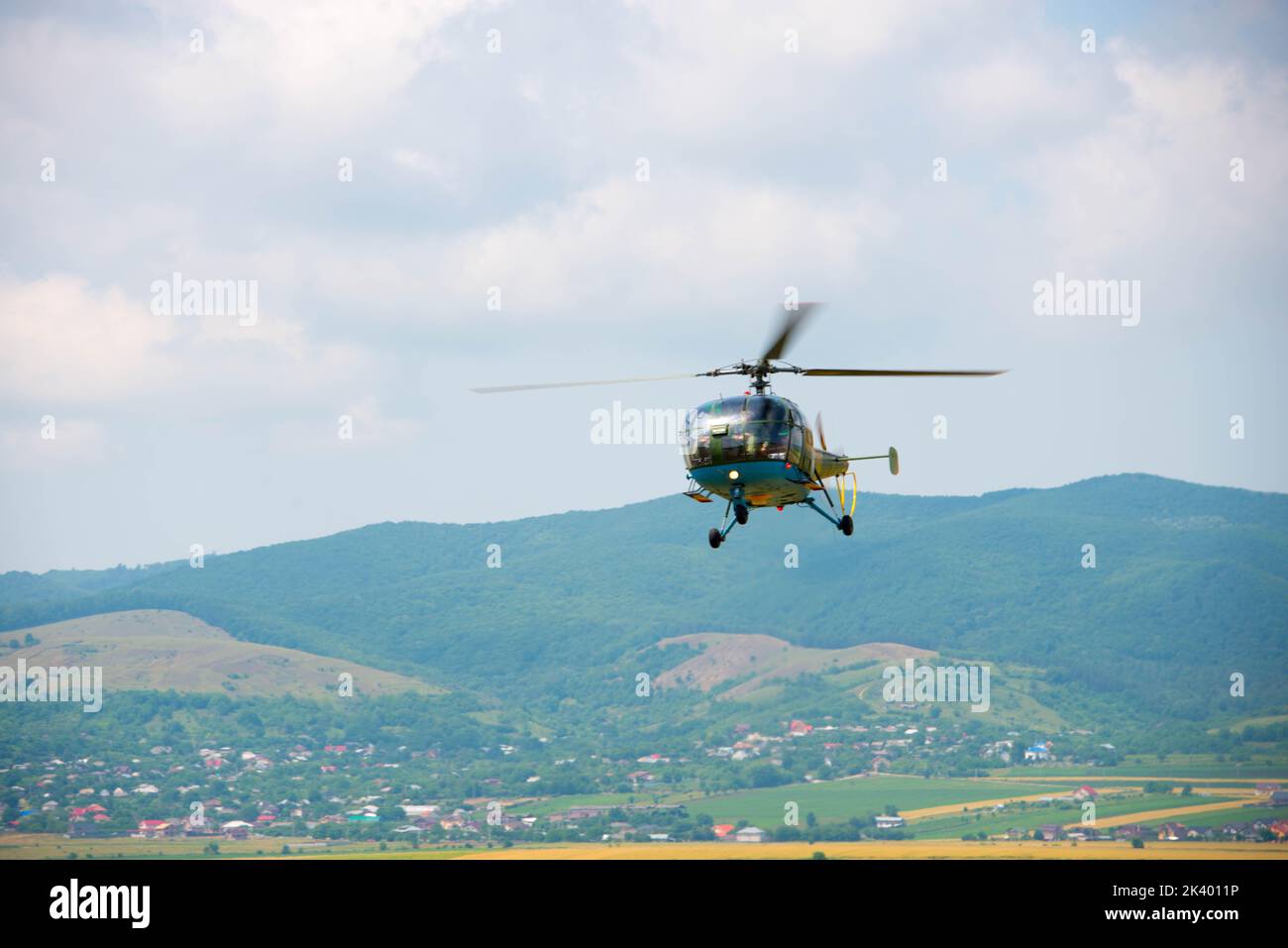 Flying helicopter over the mountains close-up Stock Photo - Alamy