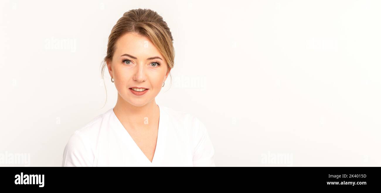 Close-up portrait of young smiling female caucasian healthcare worker ...