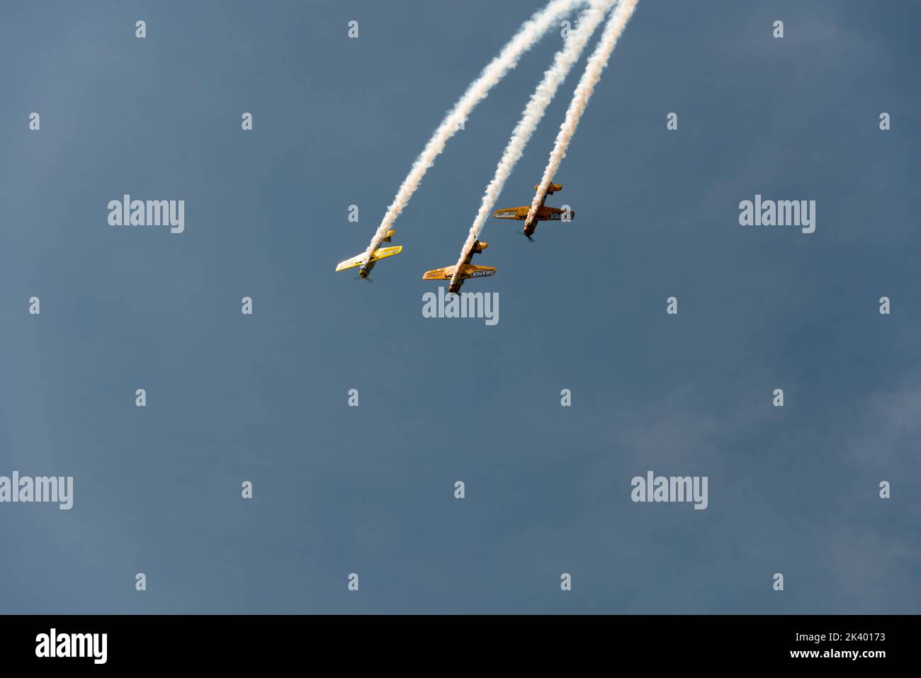 Airplane stunts being performed on the blue sky Stock Photo - Alamy