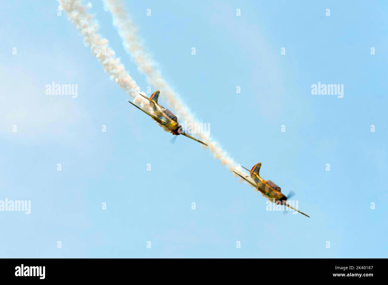 Barrel Roll of two propeller planes on a clear sky Stock Photo - Alamy