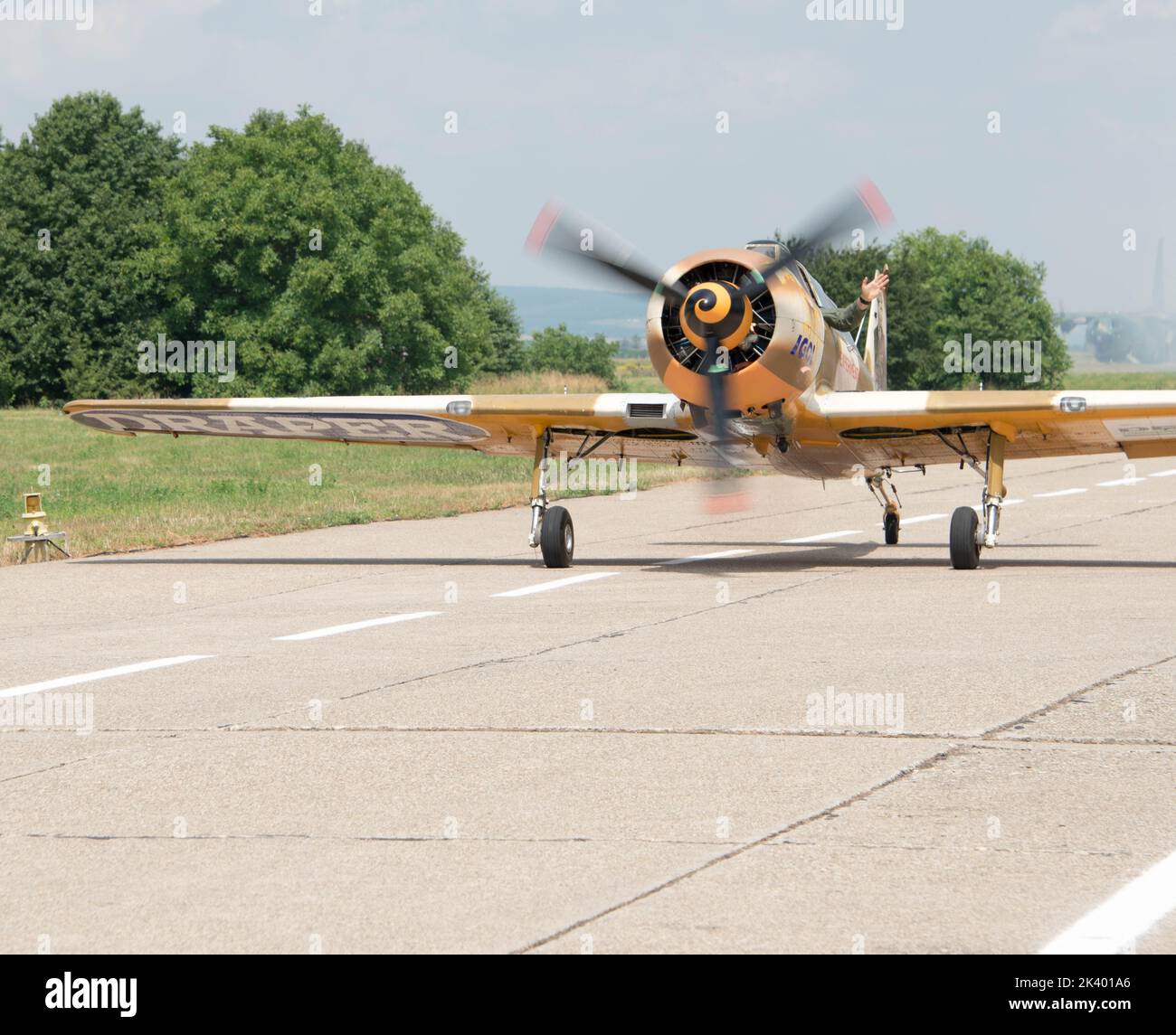 Propeller plane taking off from the ground Stock Photo - Alamy