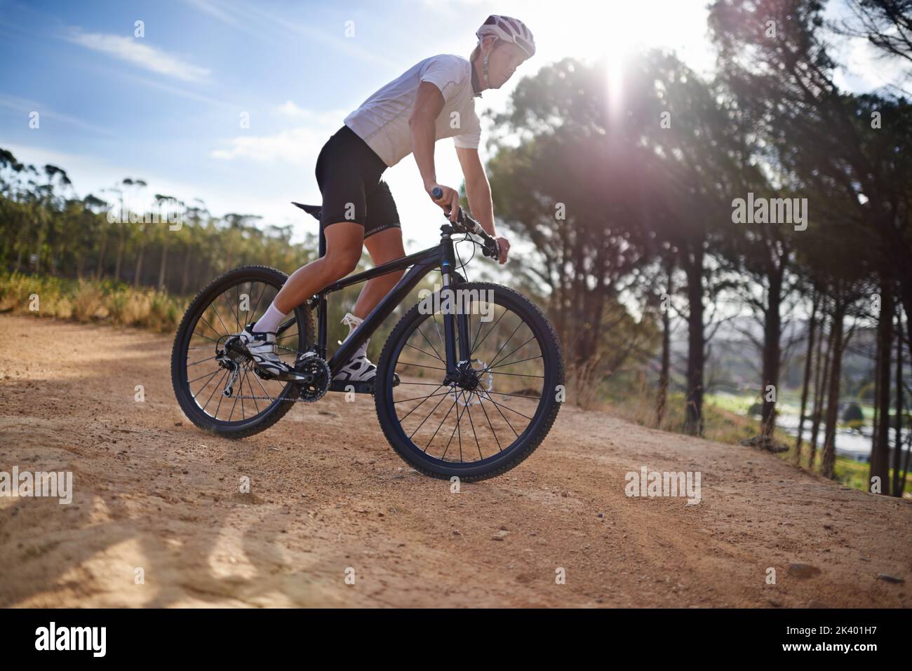 Nothing beats an extreme bike ride. Fit cyclist riding across rough ...