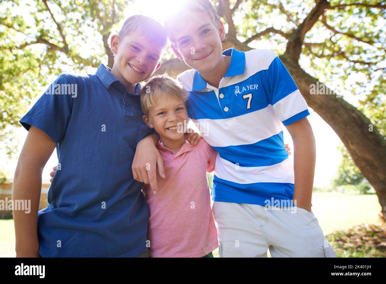 Spending time with his big brothers. Three brothers hugging one another ...