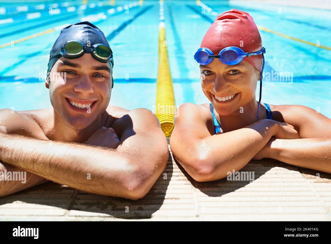 The perfect day for a swim. Two young swimmers smiling broadly at the ...