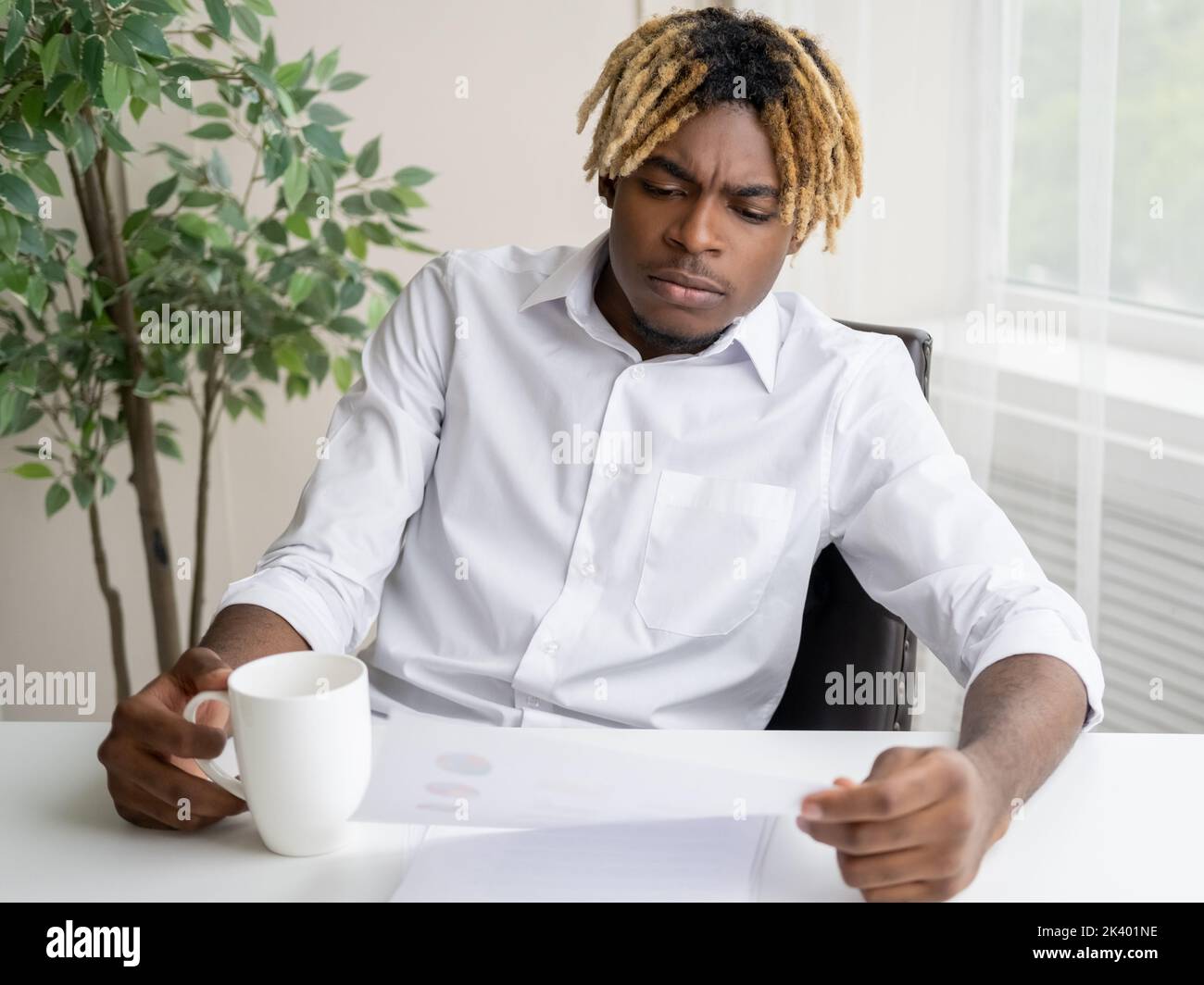 Office routine. Gloomy black man. Checking documents. Handsome serious ...