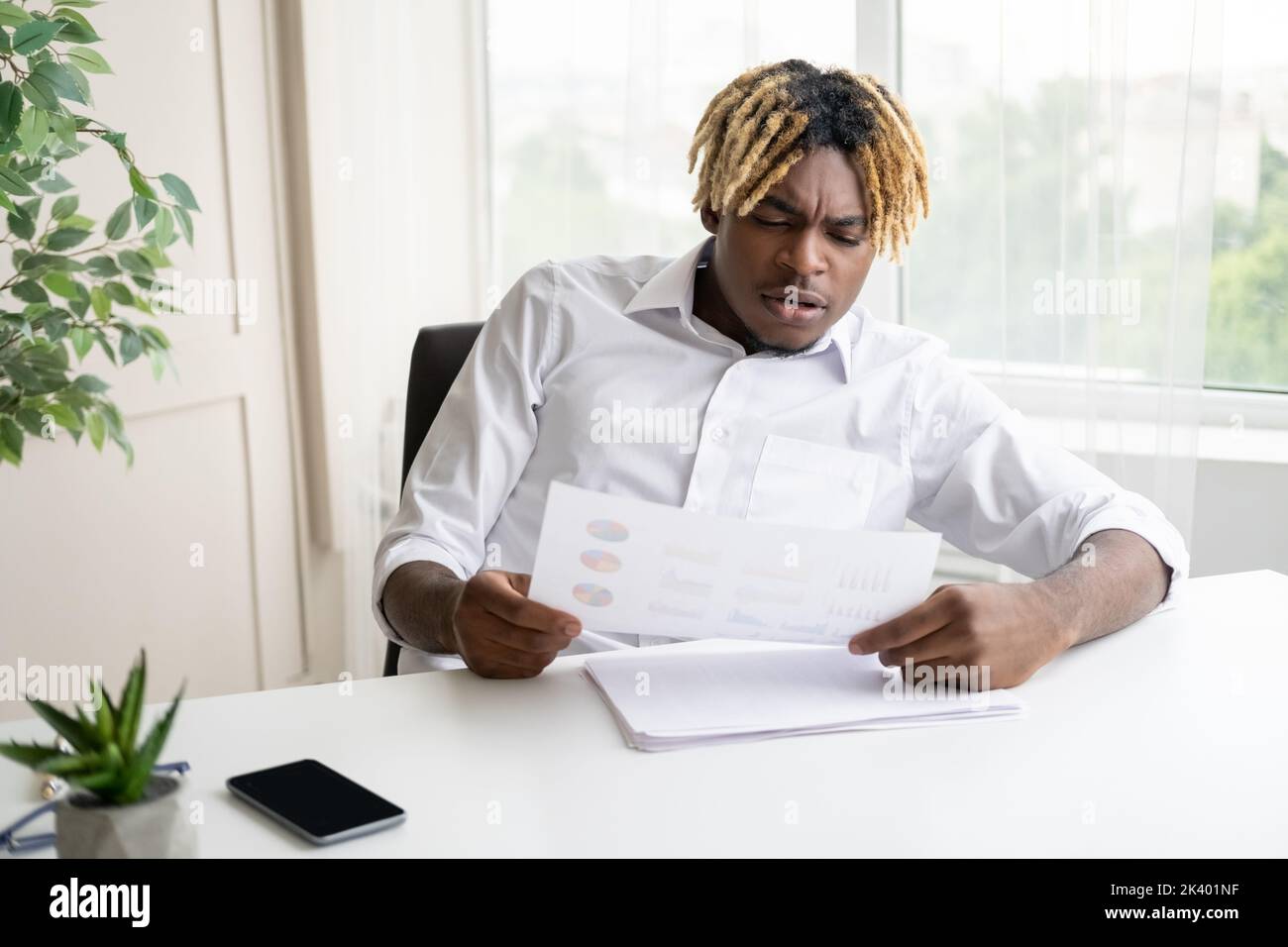 Considering problem. Worried black man. Check report. Handsome serious ...