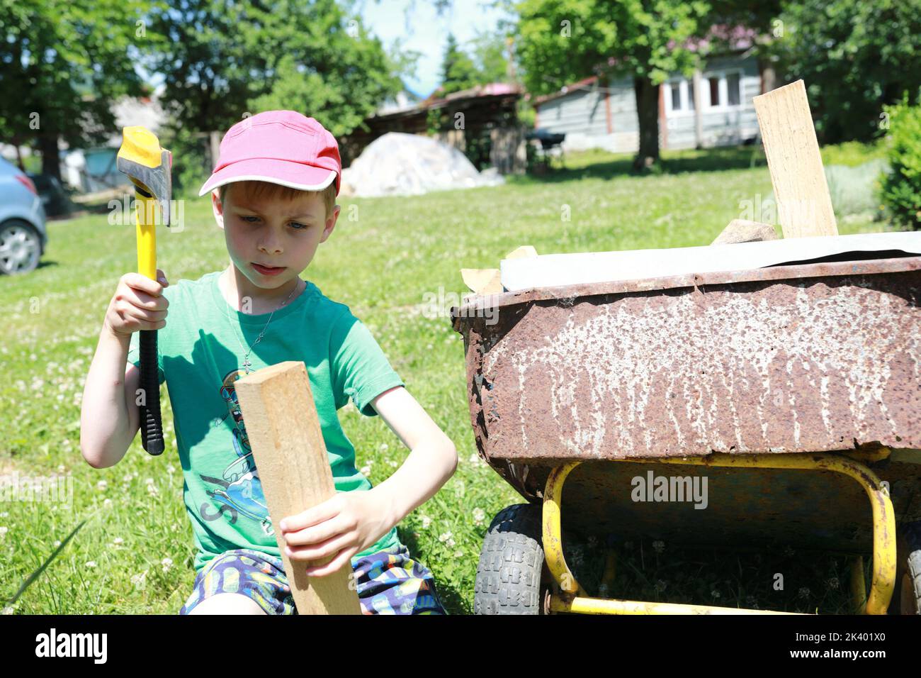 Child chopping wood with ax in backyard Stock Photo - Alamy
