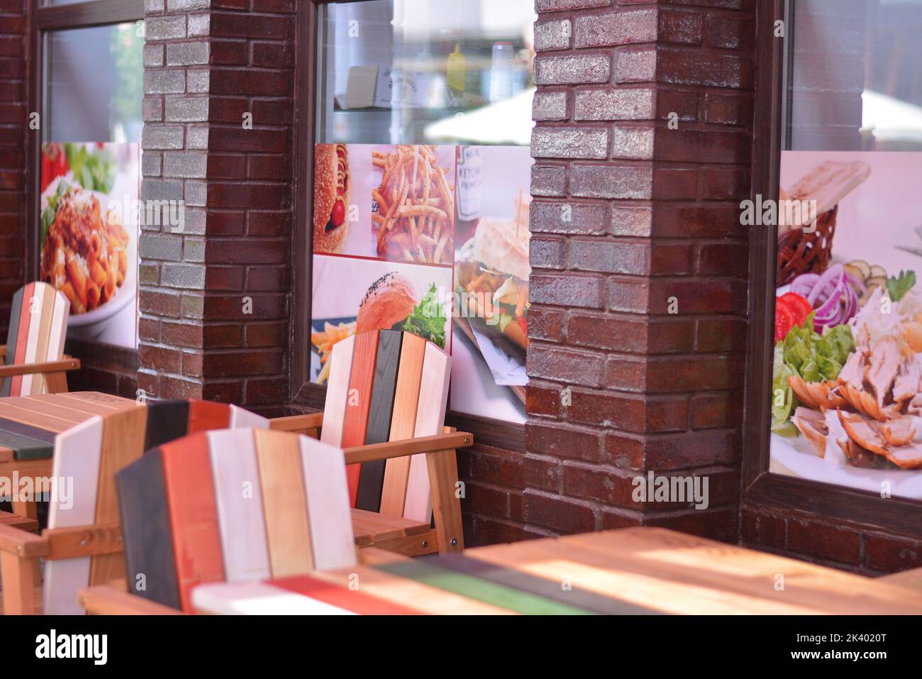 Colored wooden chairs and tables. Terrace of a fast food restaurant ...