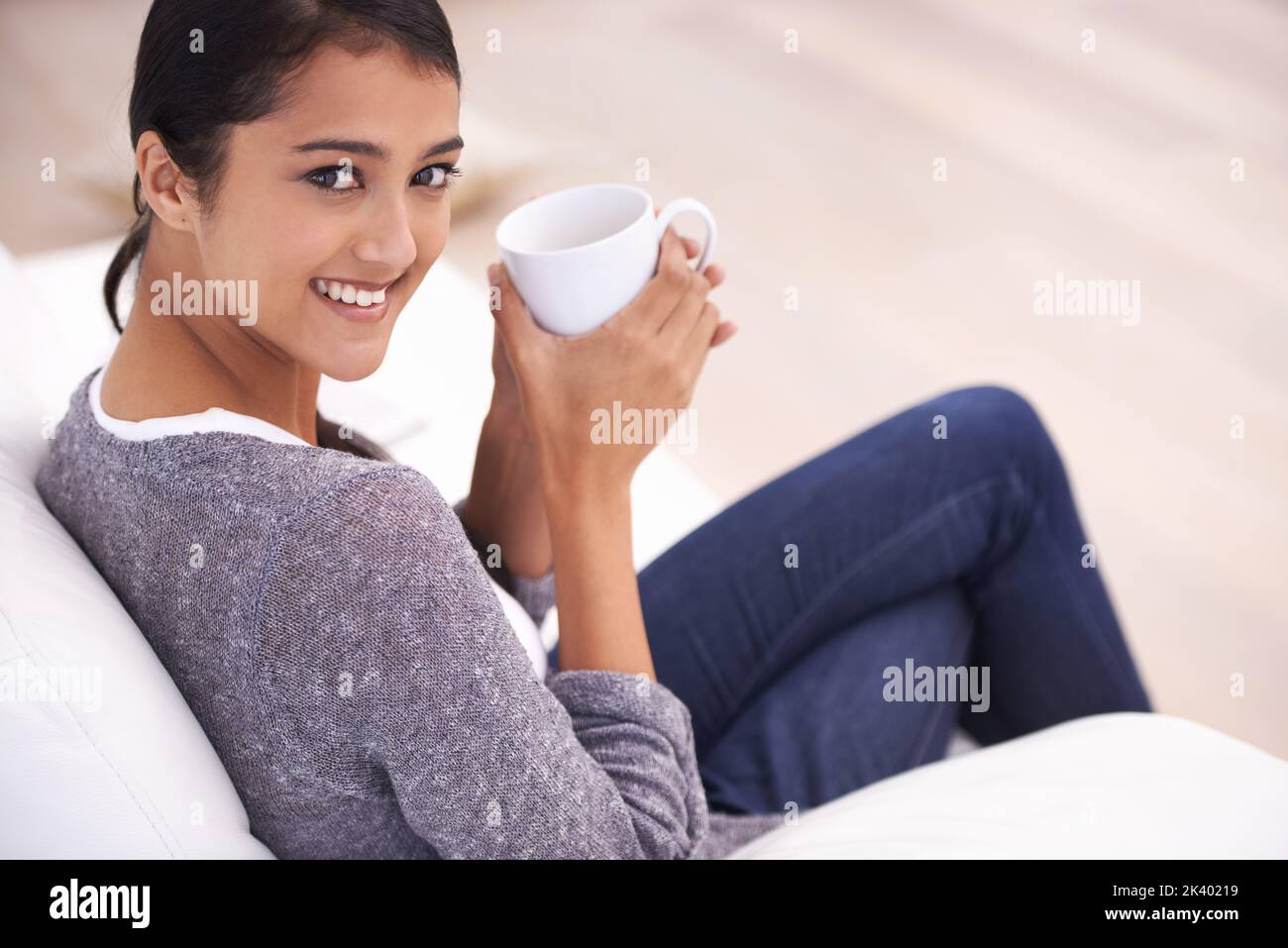 Relaxing on the weekend. Portrait of a young woman relaxing on the sofa ...