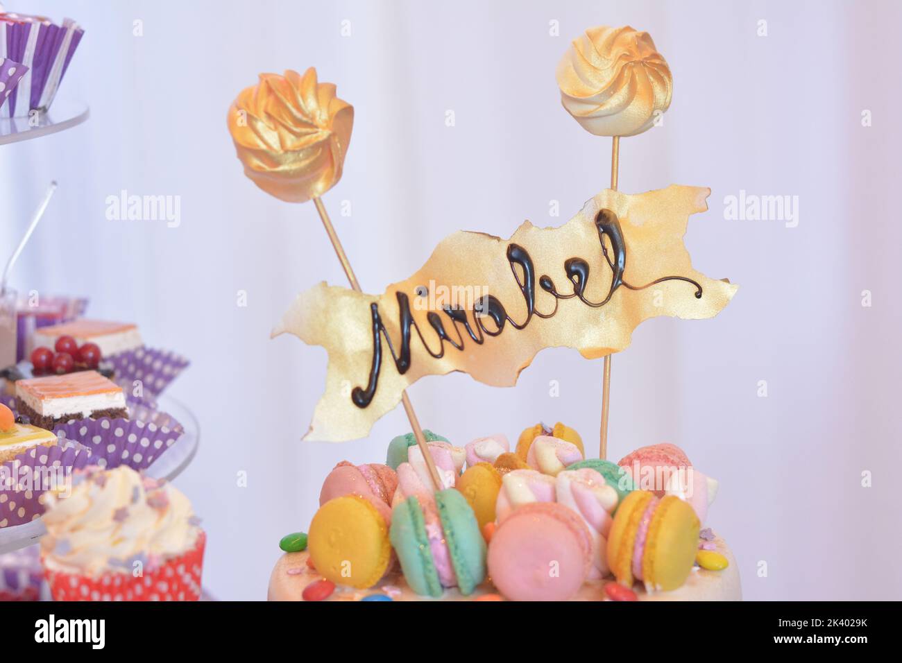 Colorful macarons cake with the name "Mirabel". Top view Stock Photo ...