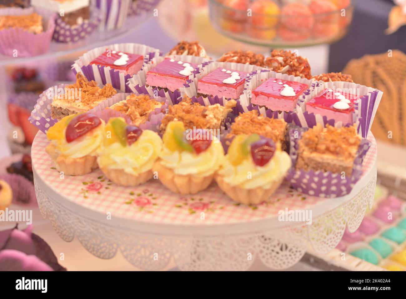 Plate with assorted cakes: cream and strawberry jelly cakes, walnut and ...