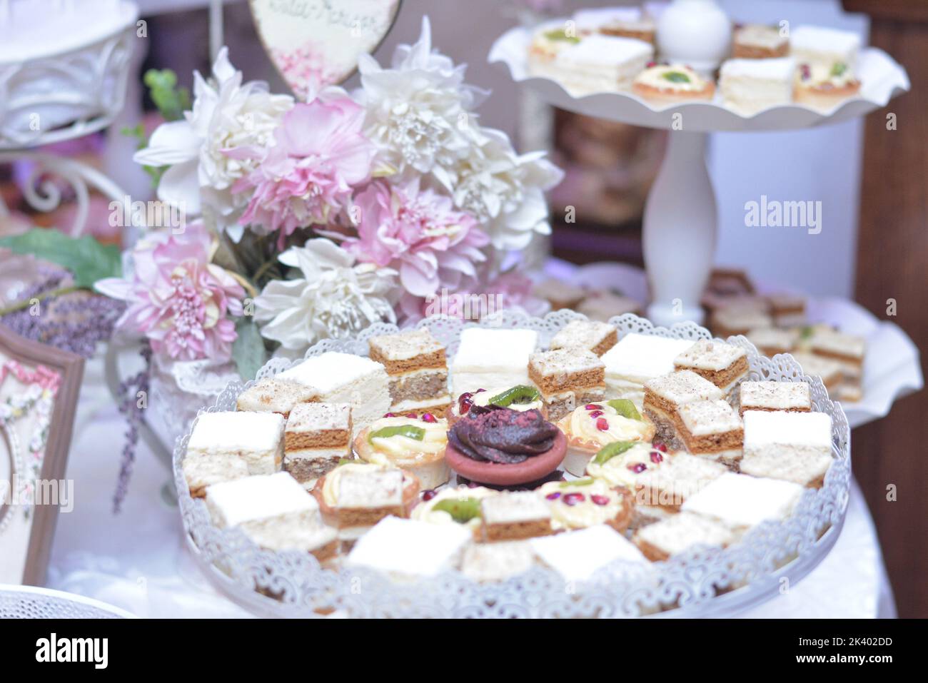 Cakes with white cream and pink flowers on background Stock Photo - Alamy