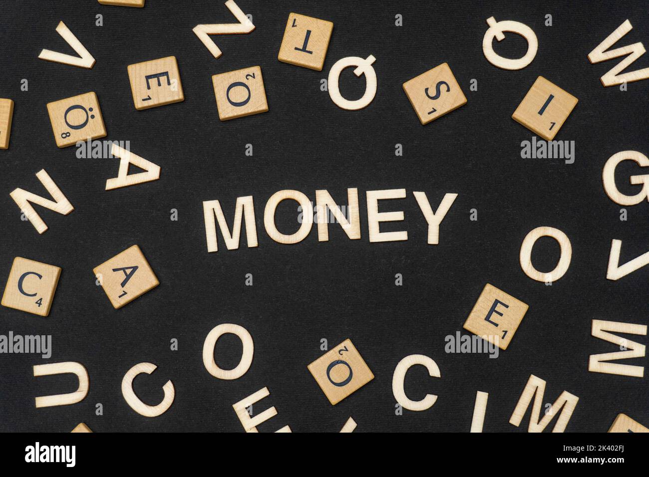 MONEY word written on dark paper background. MONEY text on dark for ...