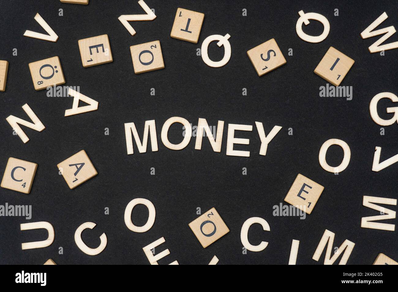 MONEY word written on dark paper background. MONEY text on dark for ...