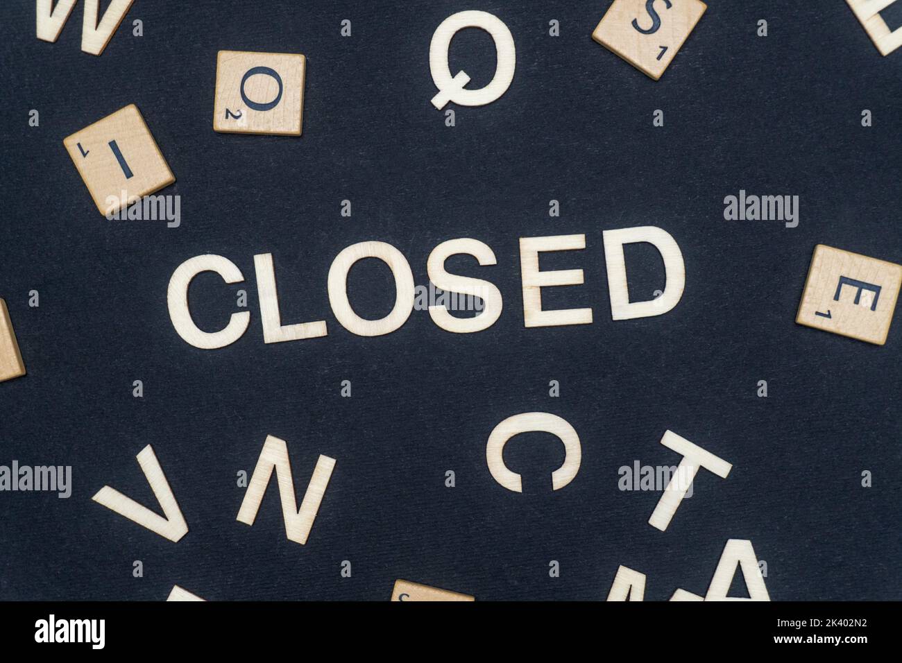CLOSED word written on dark paper background. CLOSED text on dark for ...
