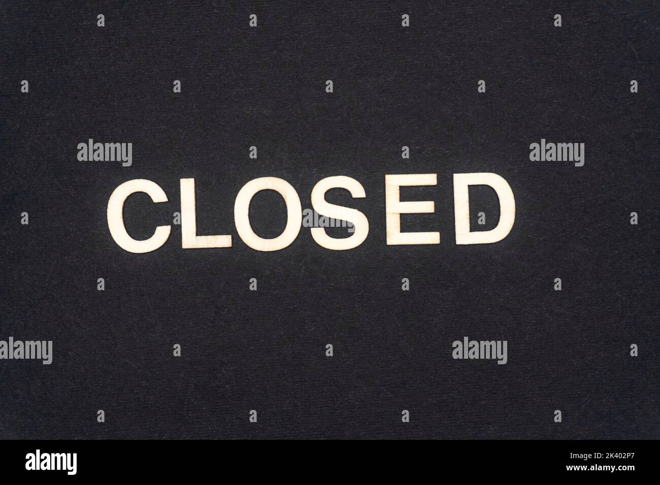 CLOSED word written on dark paper background. CLOSED text on dark for ...