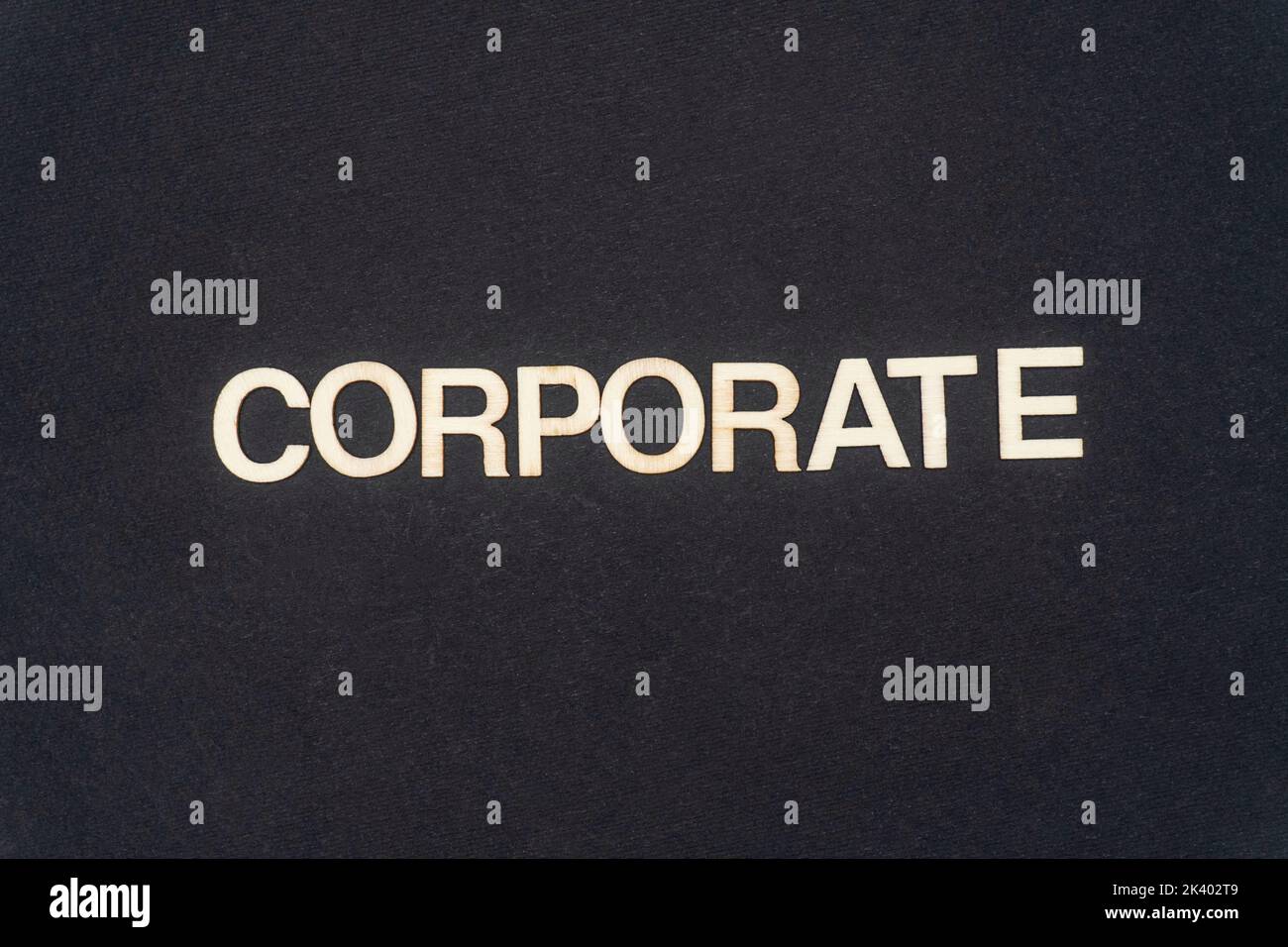 CORPORATE word written on dark paper background. CORPORATE text on dark ...