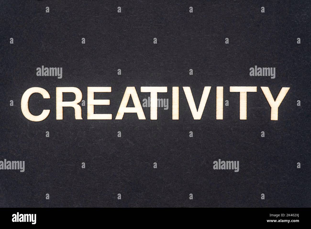 CREATIVITY word written on dark paper background. CREATIVITY text on ...
