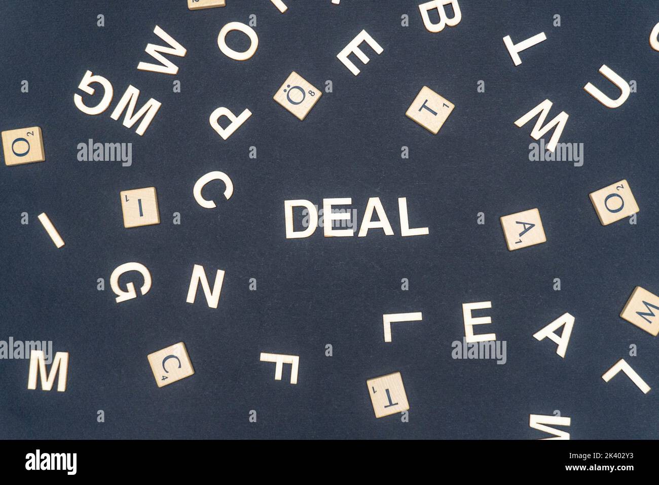 DEAL word written on dark paper background. DEAL text on dark for your ...