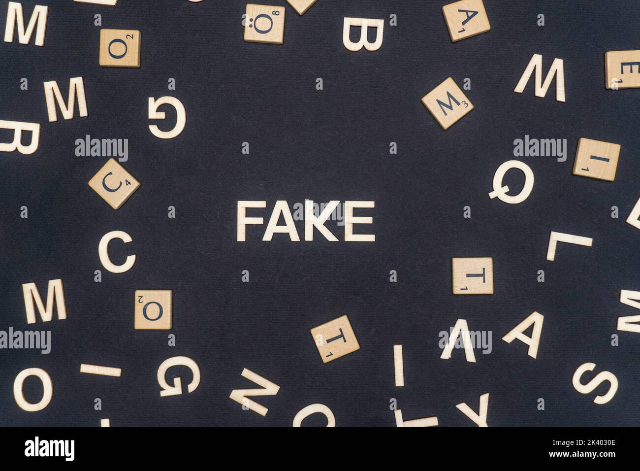 FAKE word written on dark paper background. FAKE text on dark for your ...