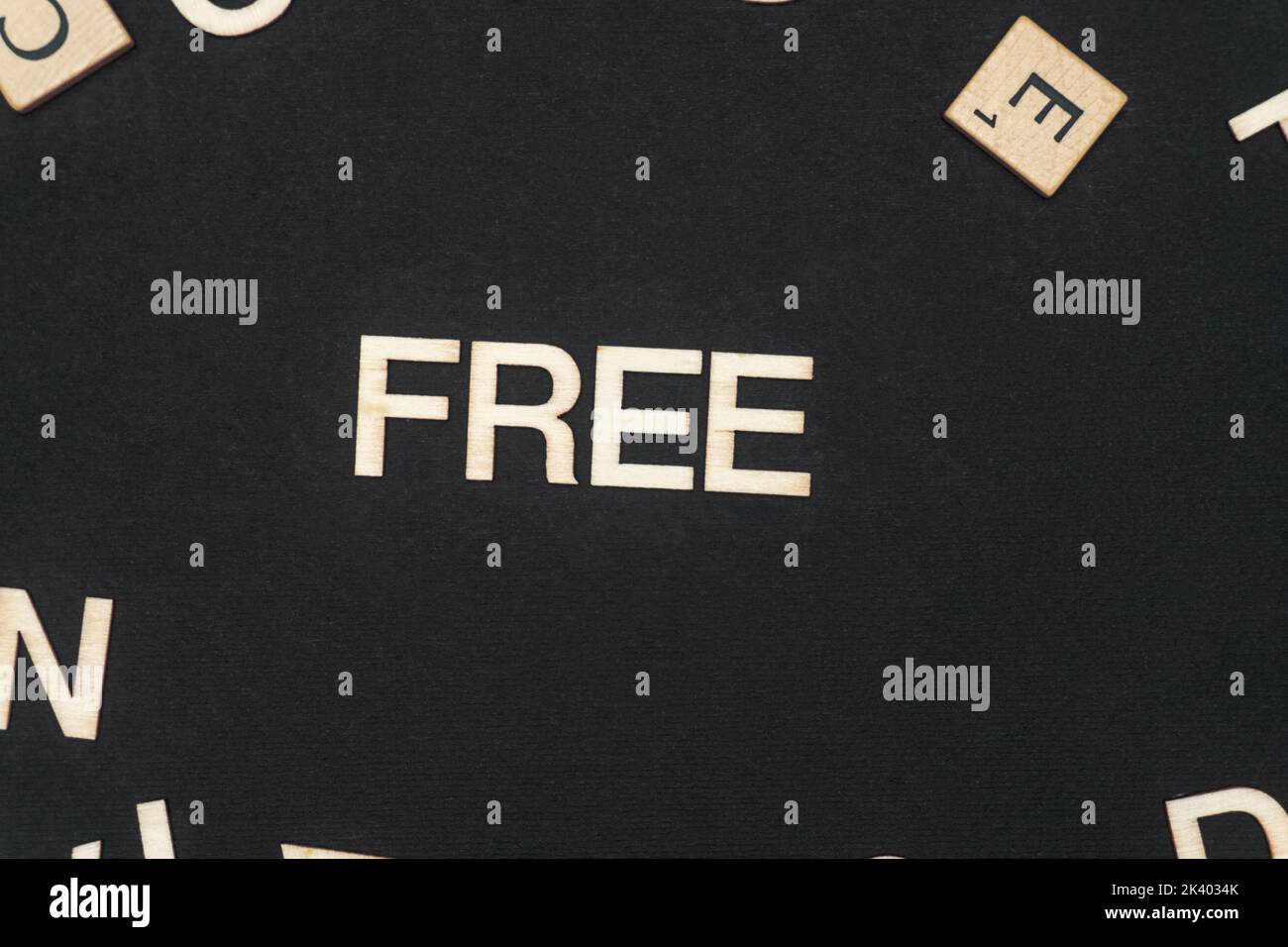 FREE word written on dark paper background. FREE text on dark for your ...