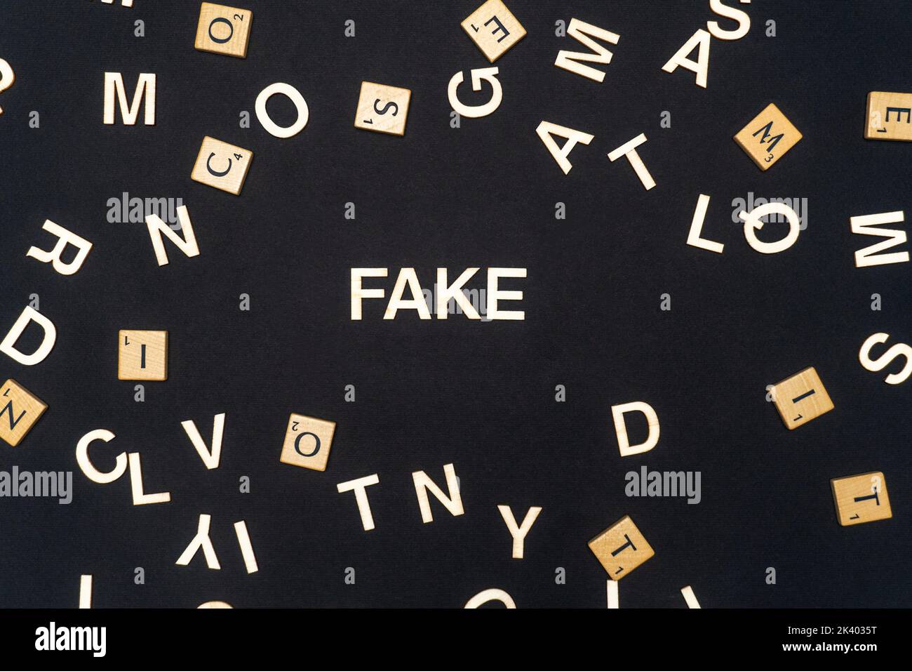 FAKE word written on dark paper background. FAKE text on dark for your ...