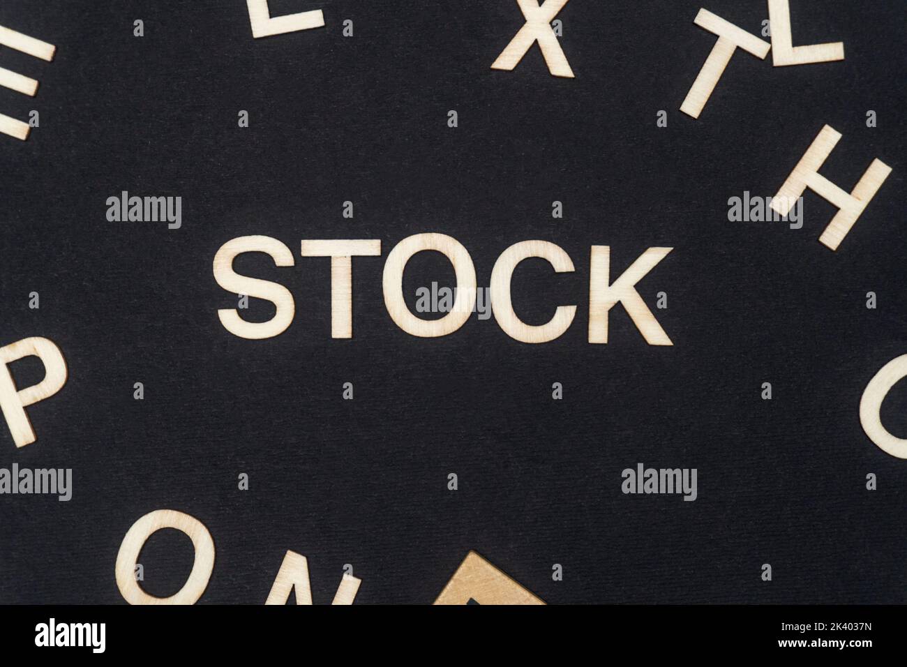 STOCK word written on dark paper background. STOCK text on dark for ...