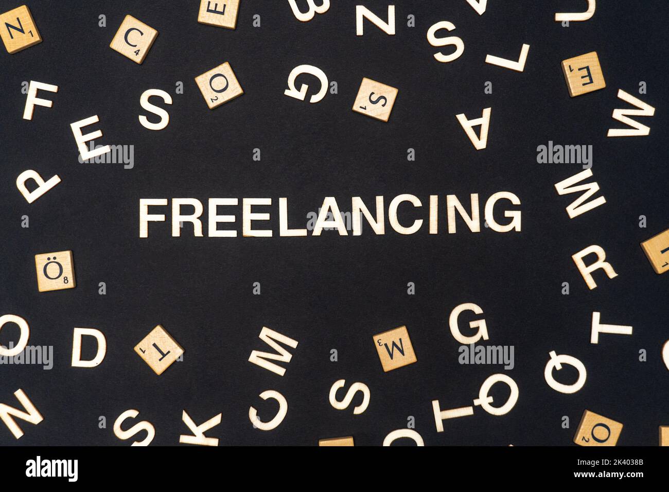 FREELANCING word written on dark paper background. FREELANCING text on ...