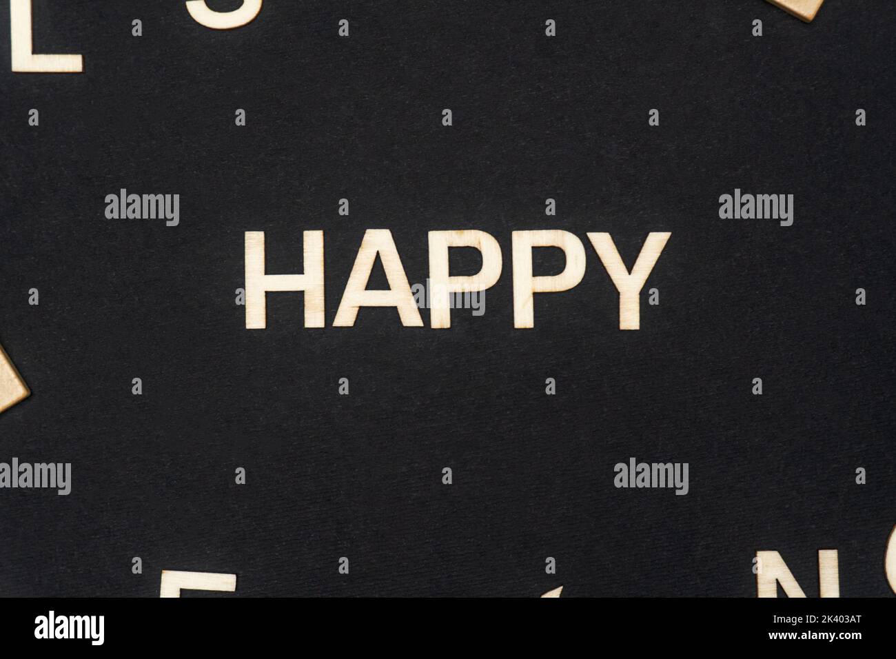 HAPPY word written on dark paper background. HAPPY text on dark for ...