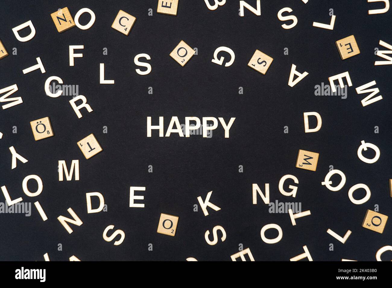 HAPPY word written on dark paper background. HAPPY text on dark for ...