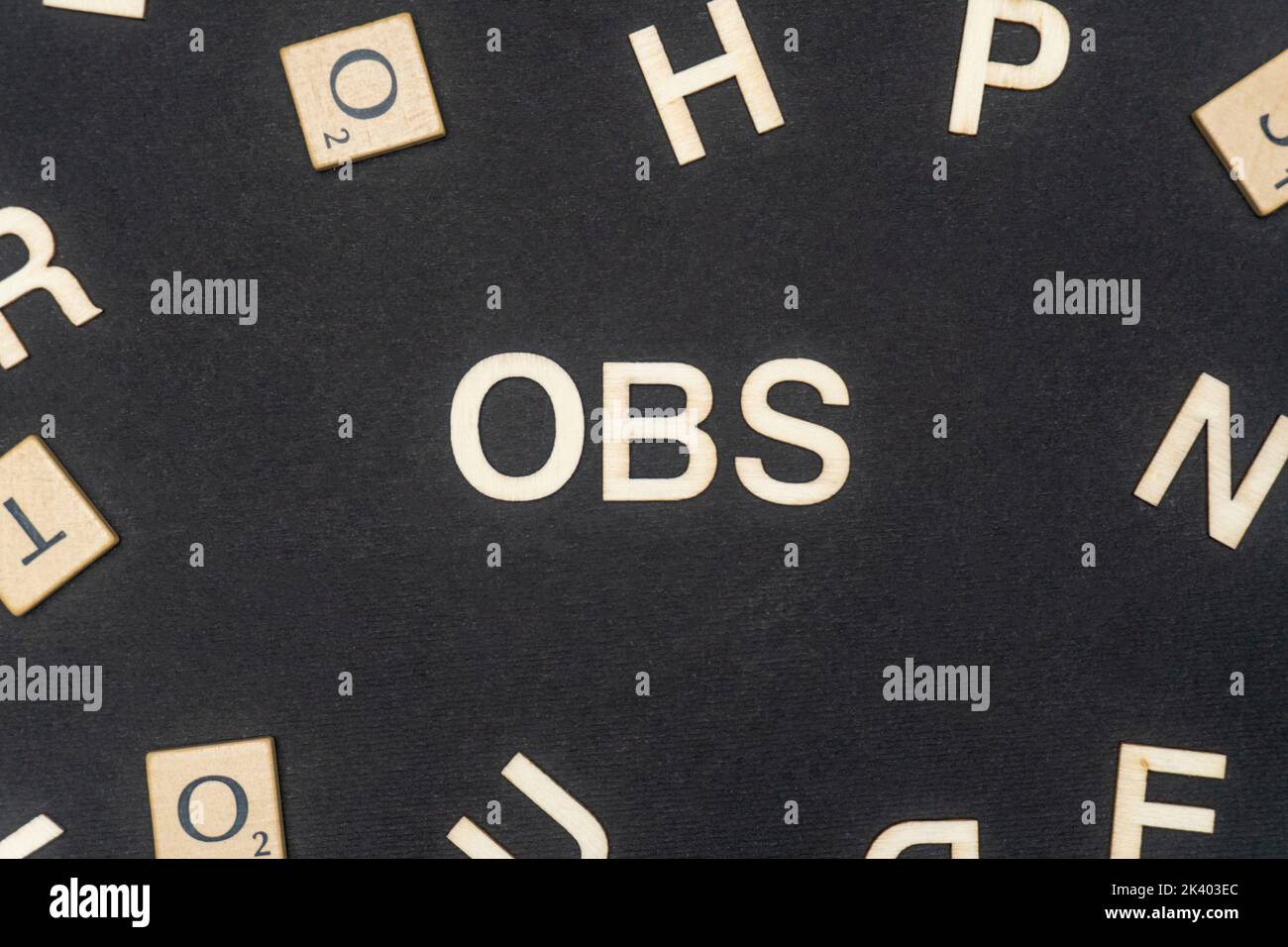 OBS word written on dark paper background. OBS text on dark for your ...